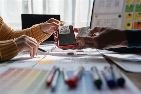 Group Of Ux Developer And Ui Designer Brainstorming About App Interface Design At Modern Office