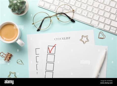 Checklist With Marked Checkbox Coffee Keyboard Glasses And Paper Clips On Light Blue