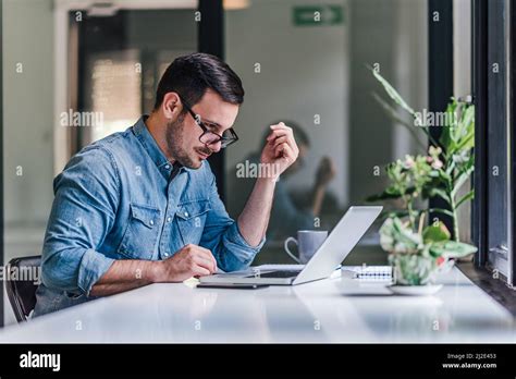 Focused Adult Man Finishing His Assignments On Time At The Office Focused Adult Man Finishing His Assignments On Time At The Office