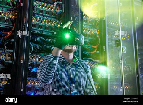 male computer programmer using virtual reality simulator glasses and