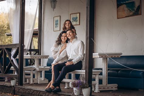 가족 어머니 아버지 및 딸은 하얀 옷을 입고 집 테라스의 초상화로 함께 아름답고 행복합니다 30 34세에 대한 스톡 사진 및