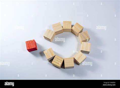Natural Colored Wooden Cubes Together Form A Circle With A Gap One Red And Standing Outside