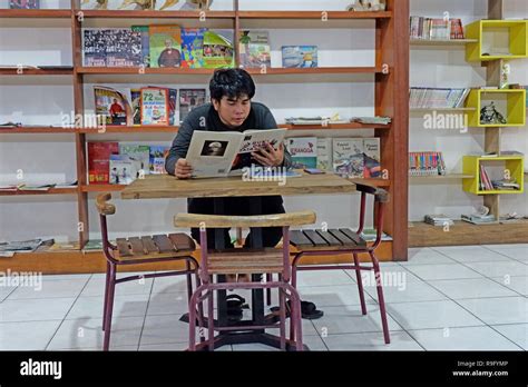 Man Reading A Book In Library Stock Photo Alamy