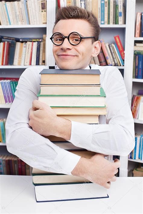 Nerd Man Hugging A Book Stack Stock Photo Gstockstudio