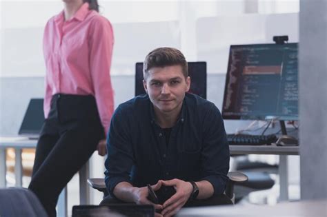 Premium Photo Programming Man Working On Computer In IT Office Sitting At Desk Writing Codes