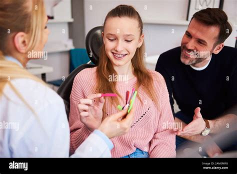 Girl Choosing The Color Of Rubber Bands For Braces Stock Photo Alamy
