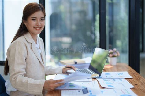 Professional Businesswoman Planning And Analyzing Marketing Charts And