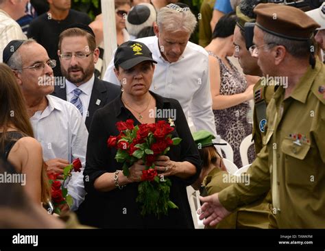 Evie Steinberg C Carries Flowers At The Funeral Of Her Slain Son