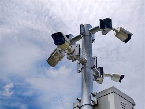 Multiple Security Cameras Installed To Ensure Safety Set Against A Beautiful Sky Background