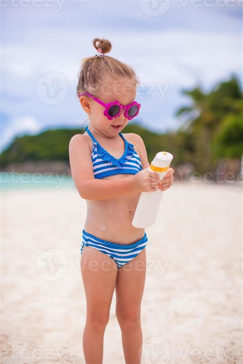 Little Cute Adorable Girl In Swimsuit Rubs Sunscreen Herself 18126721