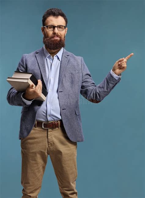 Bearded Man Holding Books And Pointing Stock Image Image Of Cheerful Beard 180050203