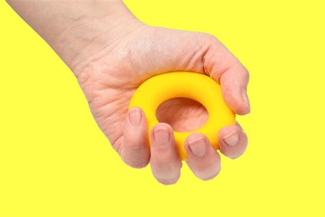 Premium Photo Yellow And Orange Expander In Woman Hand Isolated On