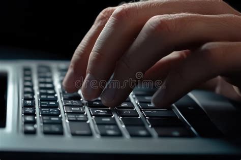 Male Hands Typing On Laptop Keyboard Coding Or Developing Software In