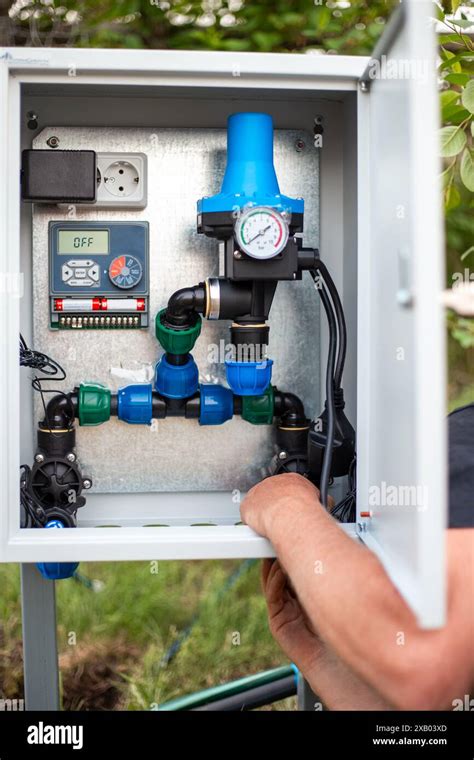 Assembling An Automatic Water Supply System For Drip Irrigation A Man