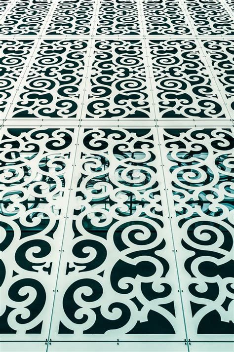 Modern Architectural Facade With Perforated Metal Panels And Swirling