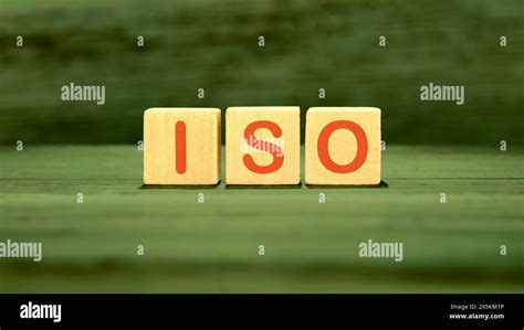 Concept Of ISO Quality Management Systems ISO TEXT WRITTEN On Wooden Cubes On Green Saturated