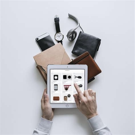 Premium Photo Hand Placing Items Into An Online Shopping Cart On A