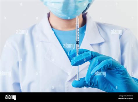 Closeup Syringe Injection Needle Of Covid Vaccine In Professional Scientist Or Doctor Hand In