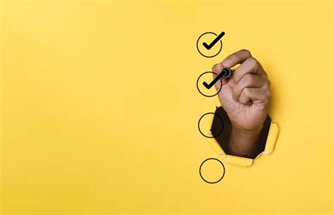 Premium Photo Hand Use Pen To Tick Correct Sign Mark In Checkbox On Punched Yellow Paper For