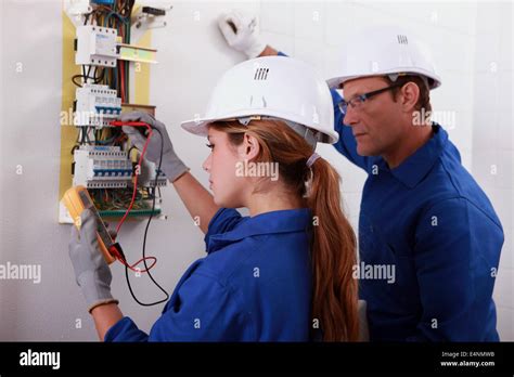 Man And Woman Measuring Voltage Stock Photo Alamy