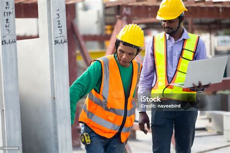 아시아의 인도 건설 건축가 엔지니어링 남자와 안전 안전모의 선임 노동자는 조립식 콘크리트 공장에서 노트북 컴퓨터 작업을 하고 있다 중공업 20 24세에 대한 스톡 사진 및