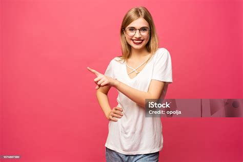 Photo Of Happy Young Woman Standing Isolated Over Pink Background
