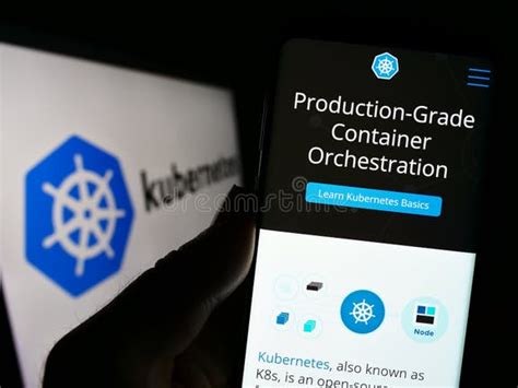 Person Holding Smartphone With Website Of Container Orchestration System Kubernetes On Screen In