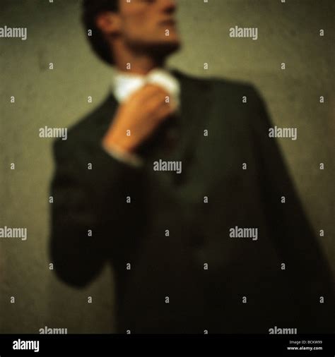 Businessman Adjusting Tie Blurred Stock Photo Alamy