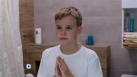 Teenage Boy Washing His Face With Cleanser Morning Skin Care At Home