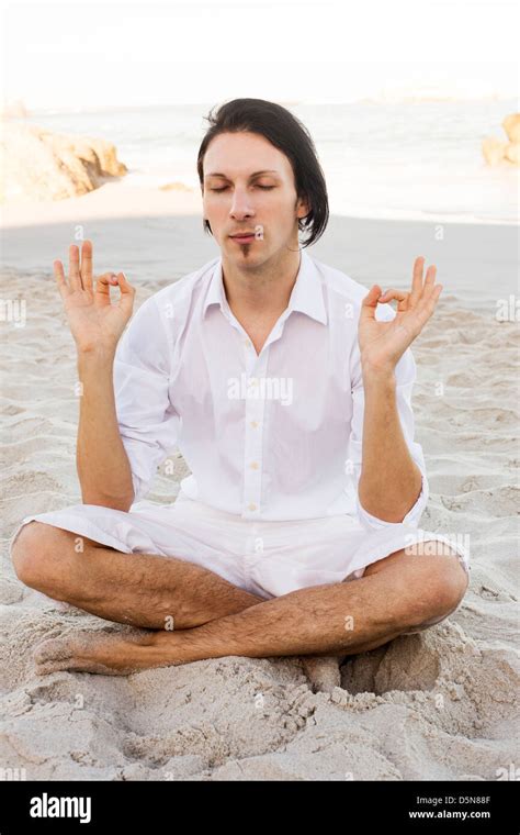 Man Meditating On Beach Stock Photo Alamy