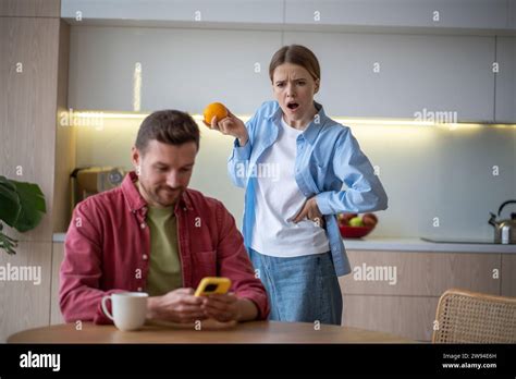 Shocked Wife Prying Into Man Mobile Phone While Joyful Husband Secretly