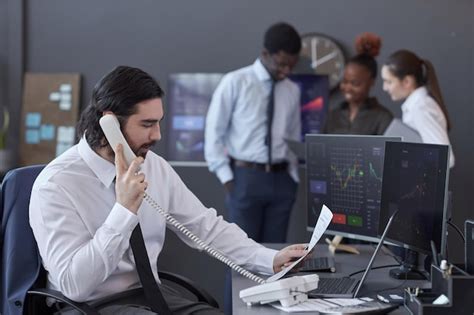 Premium Photo Trader Talking On The Phone In Office