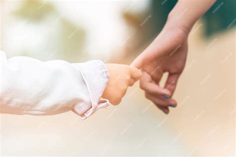 Premium Photo Close Up Of A Brother Holding Sisters Finger