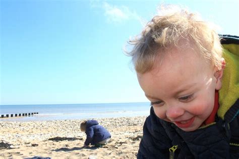 Premium Photo Siblings Playing On Sand At Beach