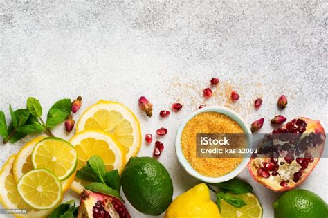 상쾌한 음료 레모네이드 모히토 또는 차가운 상쾌한 차를 위한 요리 배경 신선한 레몬 라임 석류 말린 차 장미 꽃 차 지팡이 설탕