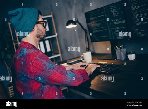 Photo Of Busy Clever Coder Dressed Hat Glasses Writing Javascript Modern Gadget Indoors