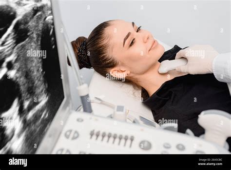 Doctor In Diagnostic Center Making Ultrasound Thyroid Gland Test Stock