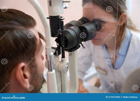 Qualified Optician Is Checking Visual Acuity In Optometrist Center