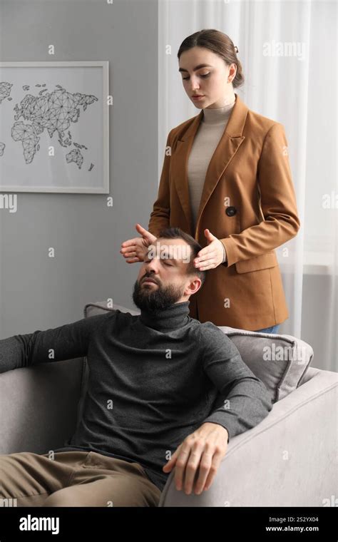 Psychologist working with patient during hypnosis session indoors Stock Photo - Alamy