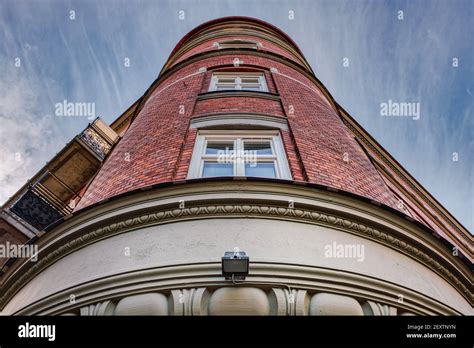 Cylindrical Classical Building Facade Made Of Bricks With Windows In