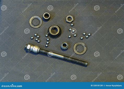 Disassembled Bicycle Hub On A Black Background Axle And Bearings For A