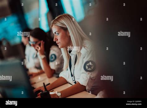 Female Security Operator Working In A Data System Control Room Offices Technical Operator