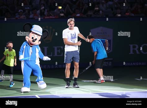 Swiss Tennis Player Roger Federer Enjoys A Dance Off With Mickey Mouse During Famiy Day Of