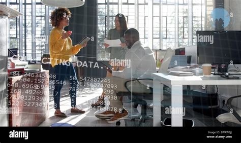 Graphs And Data Processing Over Diverse Colleagues Discussing At Casual Office Meeting Stock