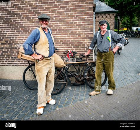 Traditional Old Dutch Clothes And Wooden Shoes On The Street Stock