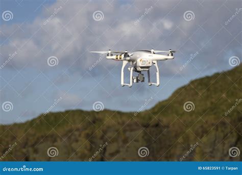 Small Unmanned Helicopter With A Camera Flying In The Blue Sky Stock