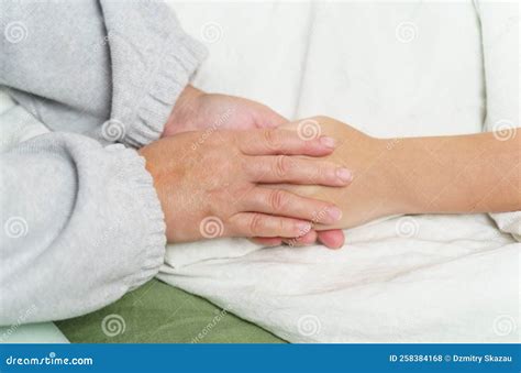 Mom Holds The Hand Of A Sick Teenager Girl Strokes Her Hand