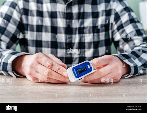 A Man Checking Oxygen Level At Home With Home Oximeter Patient Measuring The Blood Oxygen With