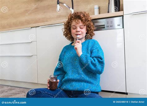 Cute Ginger Young Woman In Modern Stylish Clothes Enjoying Tasty