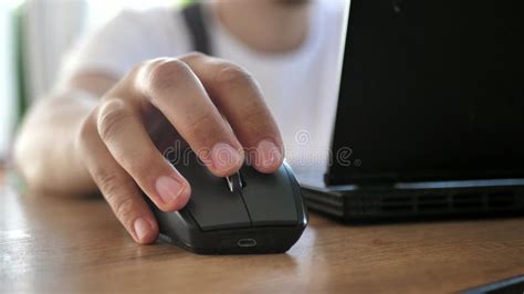 Close Up Of A Man S Hand Using A Computer Mouse While Working On A